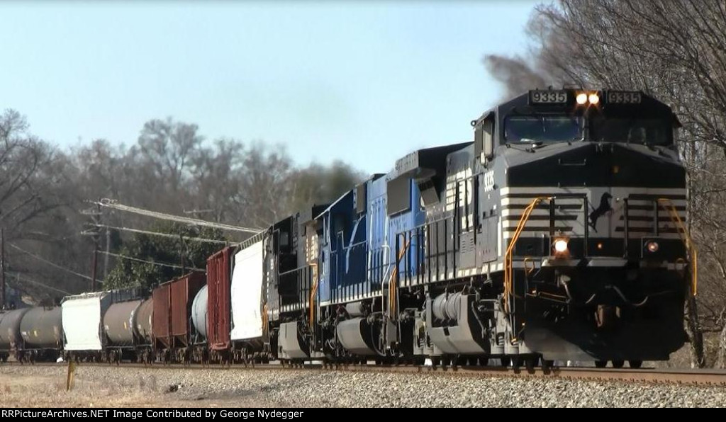 NS 9335 C40-9W leading a mixed freight train